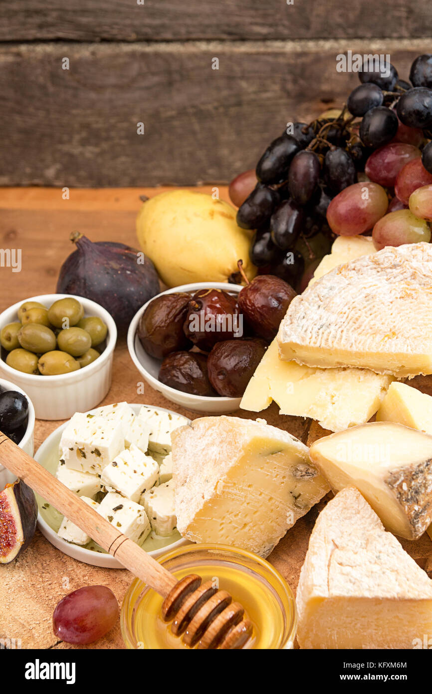 Food composition with blocks of moldy cheese, pickled plums, honey ...