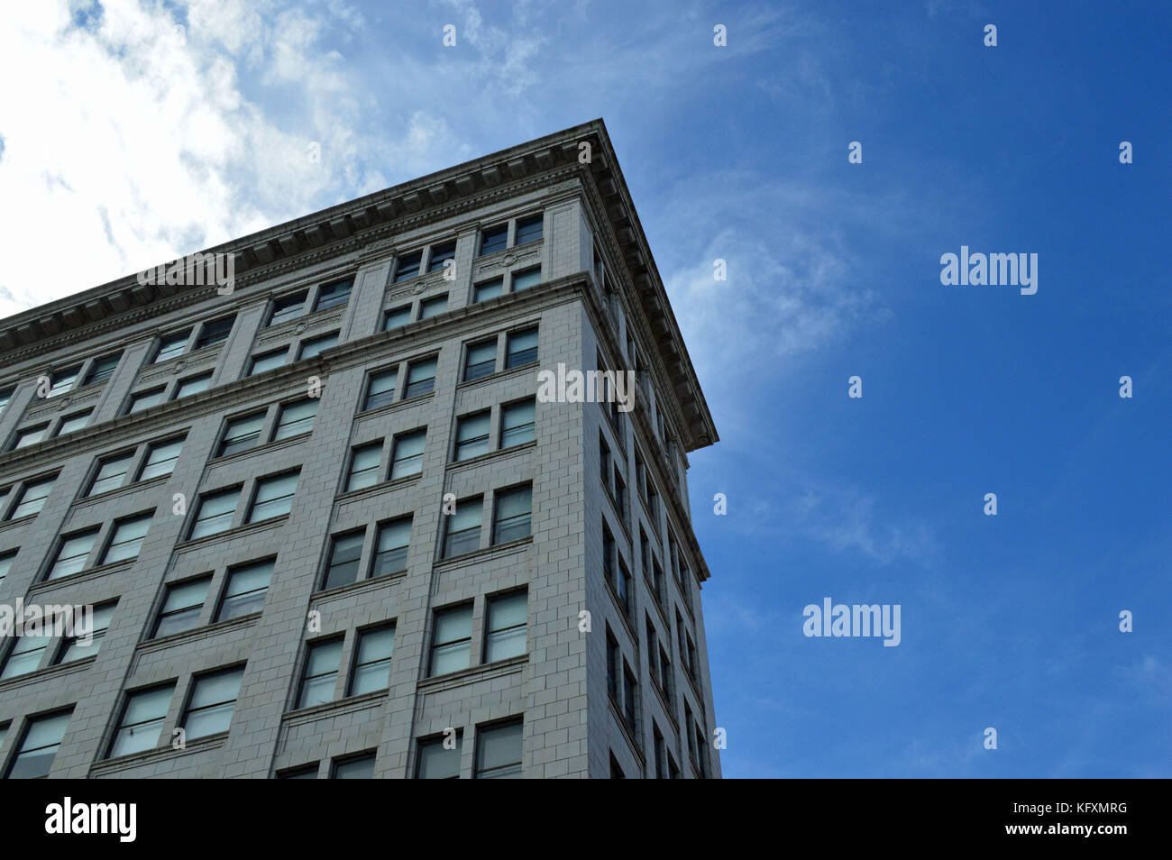 City landscape photo looking up the side of a tall building with many ...