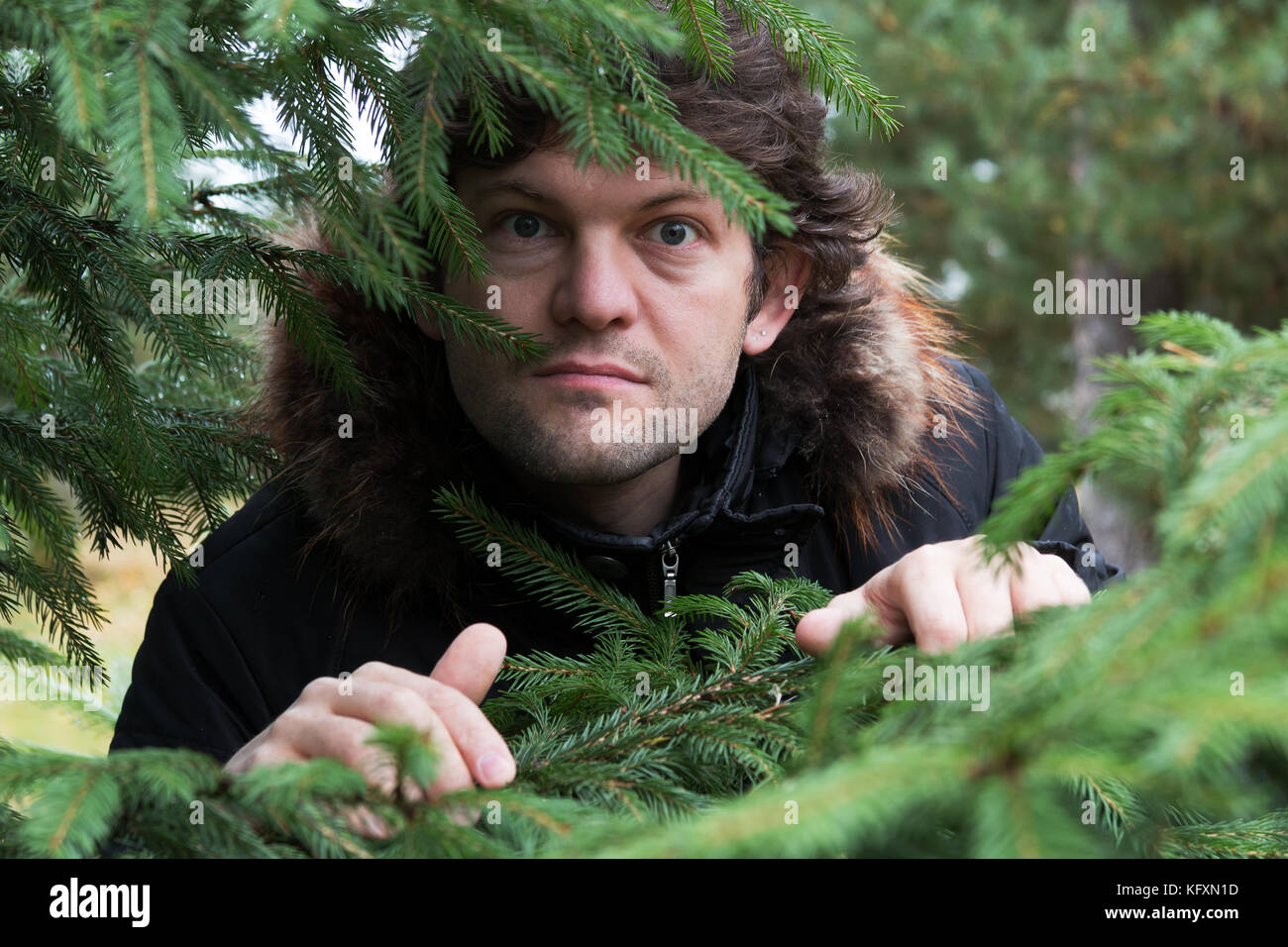 Man eyes looking through wood hi-res stock photography and images - Alamy