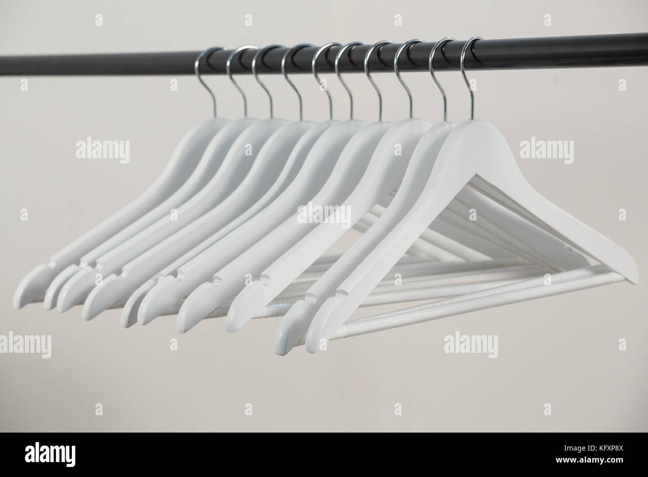 Close-up of hangers arranged on clothes rack Stock Photo - Alamy