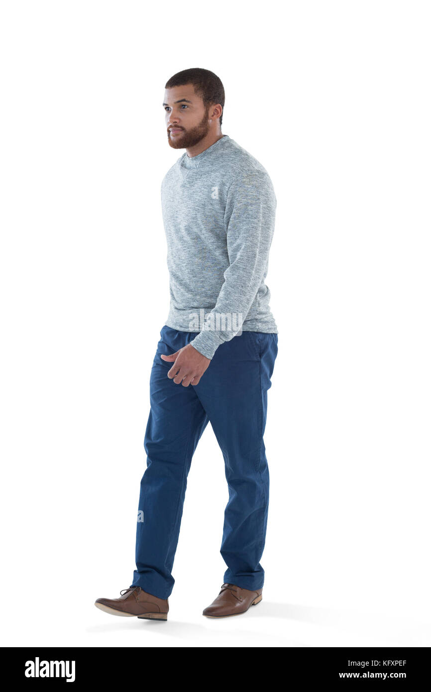 Young male executive walking against white background Stock Photo - Alamy