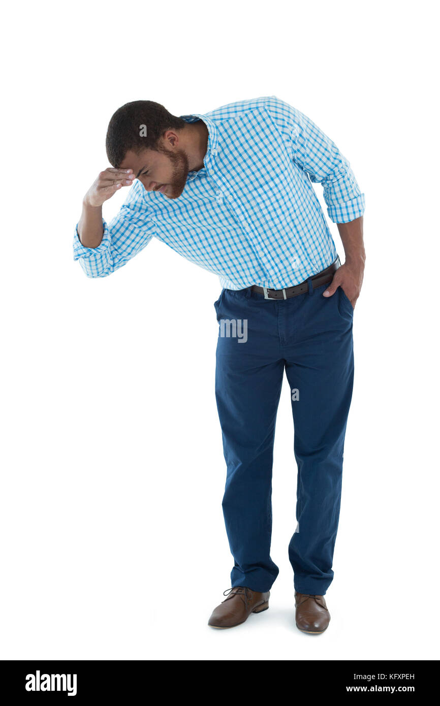 Male executive looking down against white background Stock Photo - Alamy