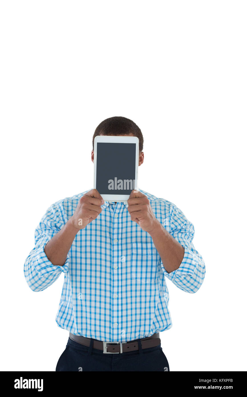 Male executive hiding his face with digital tablet against white ...