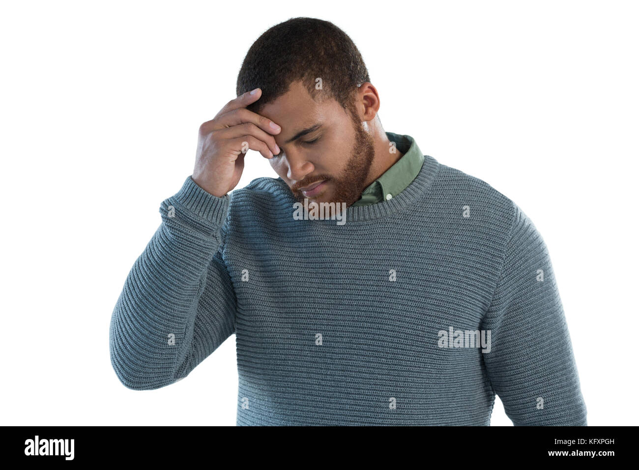 Tensed man standing against white background Stock Photo - Alamy