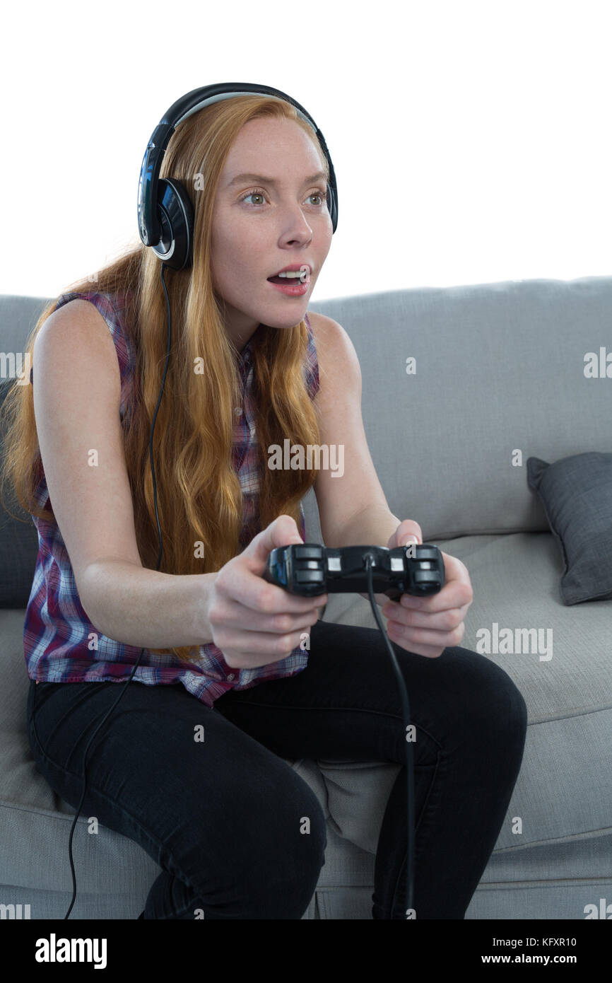 Young woman playing video game against white background Stock Photo - Alamy