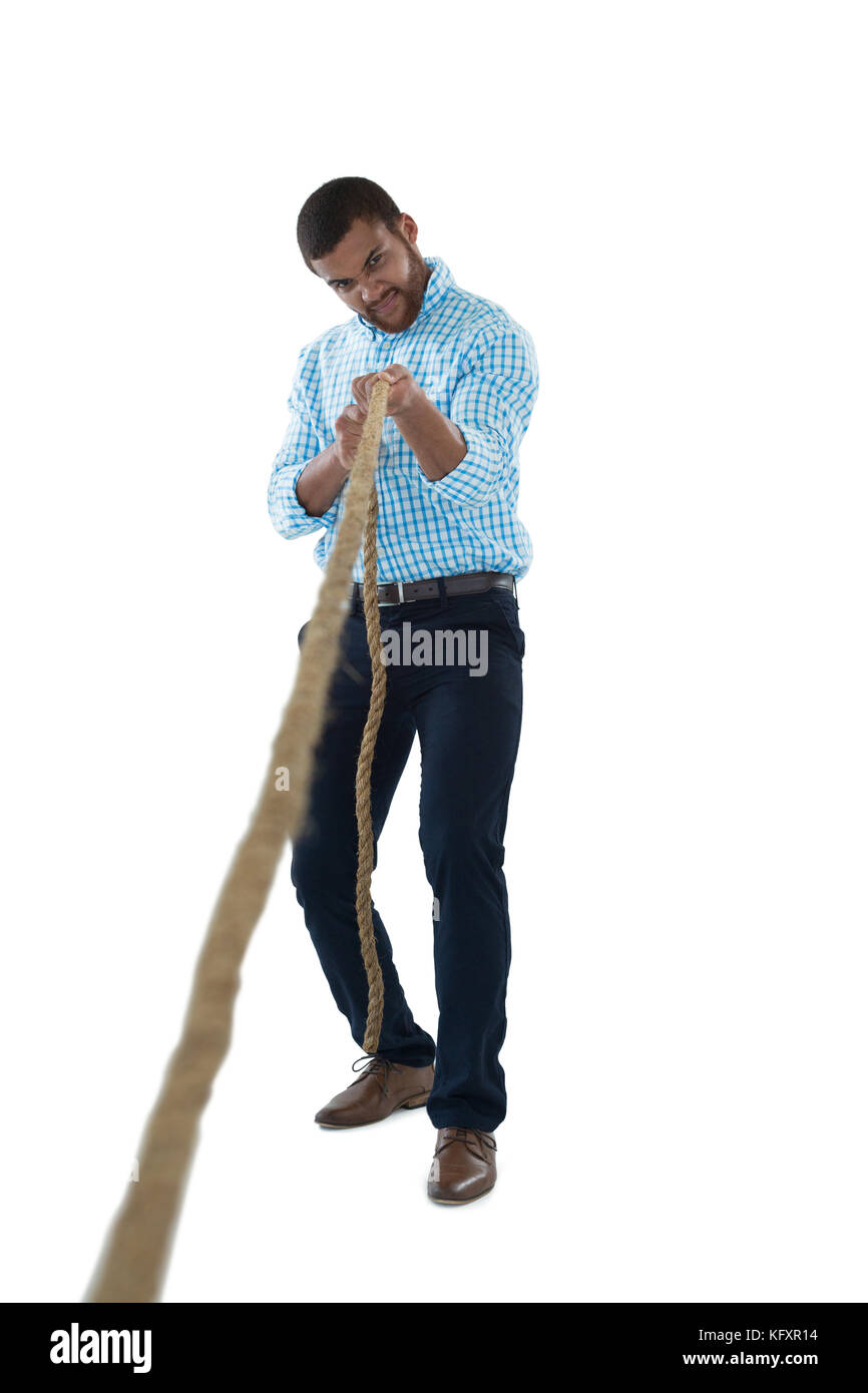 Young male executive pulling the rope against white background Stock ...