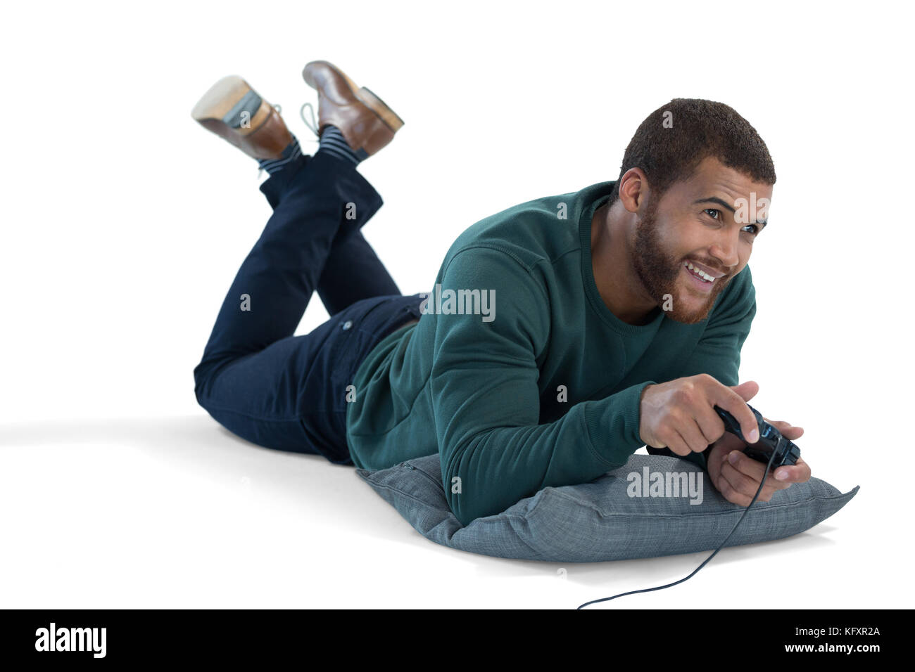 Smiling man playing video game against white background Stock Photo - Alamy