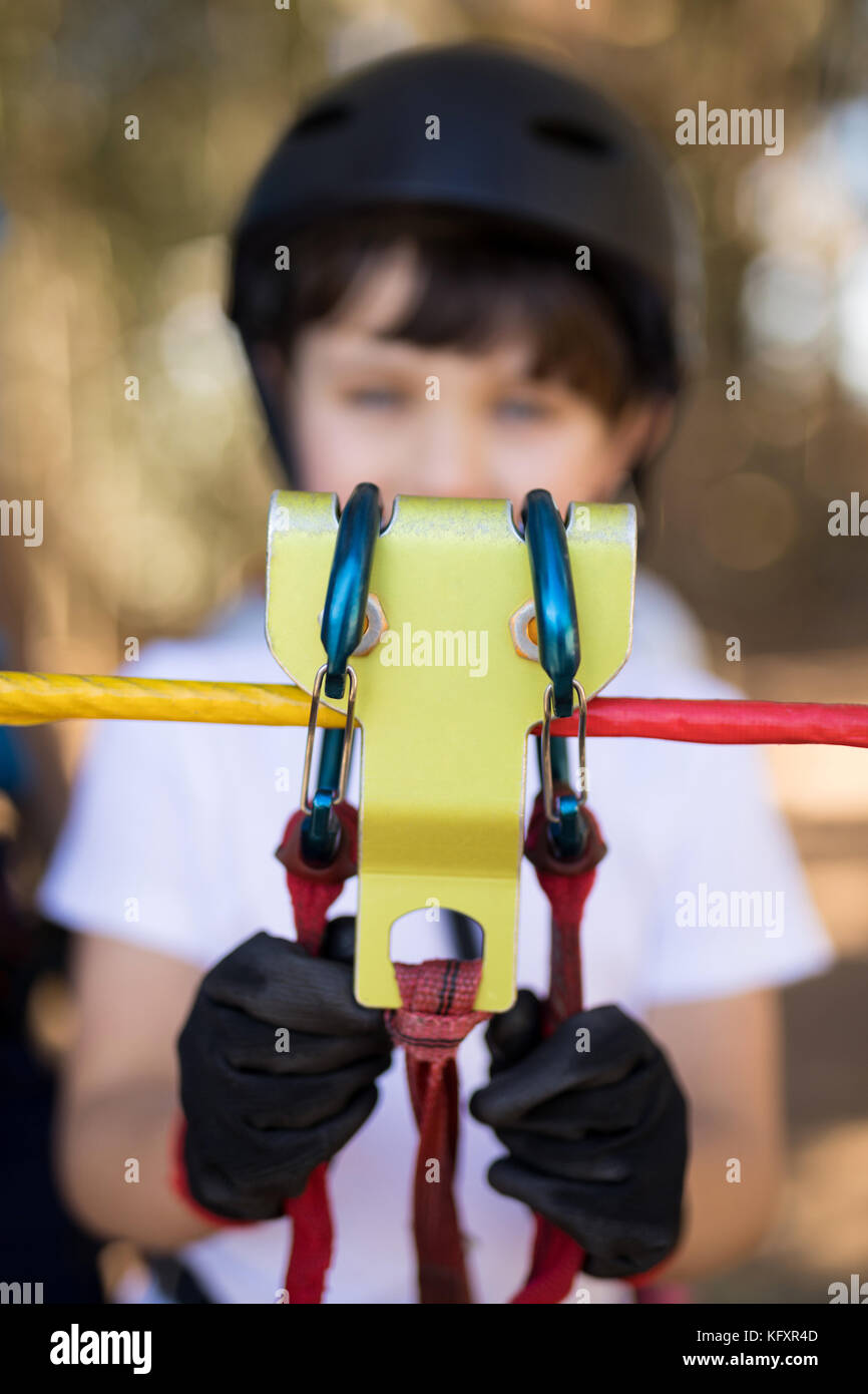 Smiling cute boy enjoying zip line adventure on sunny day Stock Photo ...