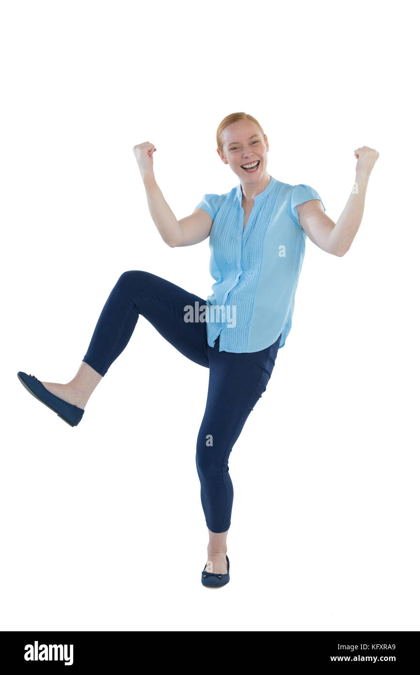 Happy female executive dancing against white background Stock Photo - Alamy