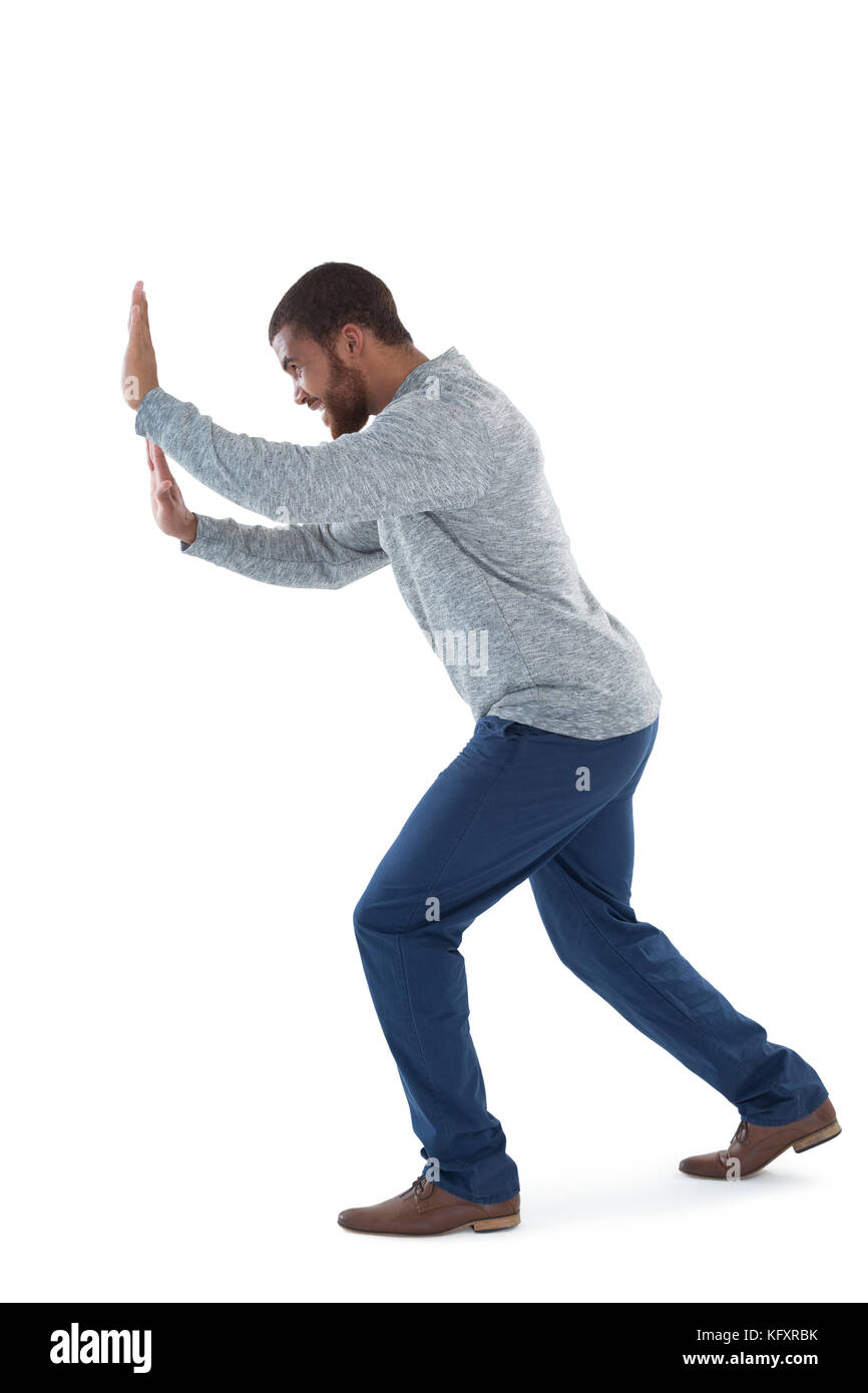 Young male executive pushing the side against white background Stock ...