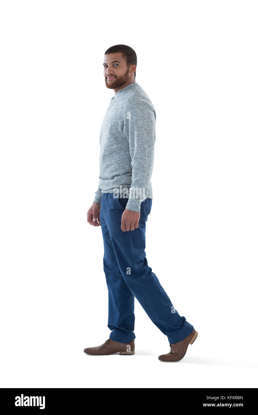 Young male executive walking against white background Stock Photo - Alamy