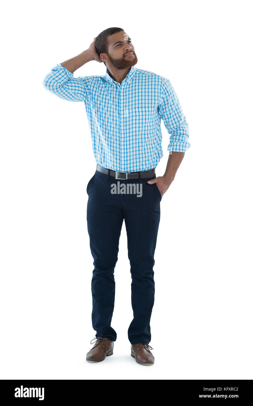 Thoughtful male executive standing against white background Stock Photo ...