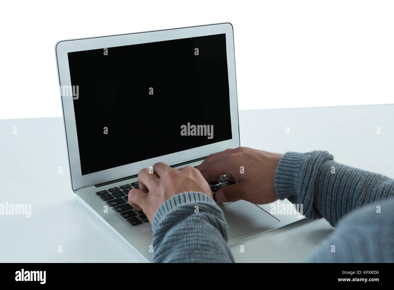 Mid-section of male executive using laptop at desk Stock Photo - Alamy