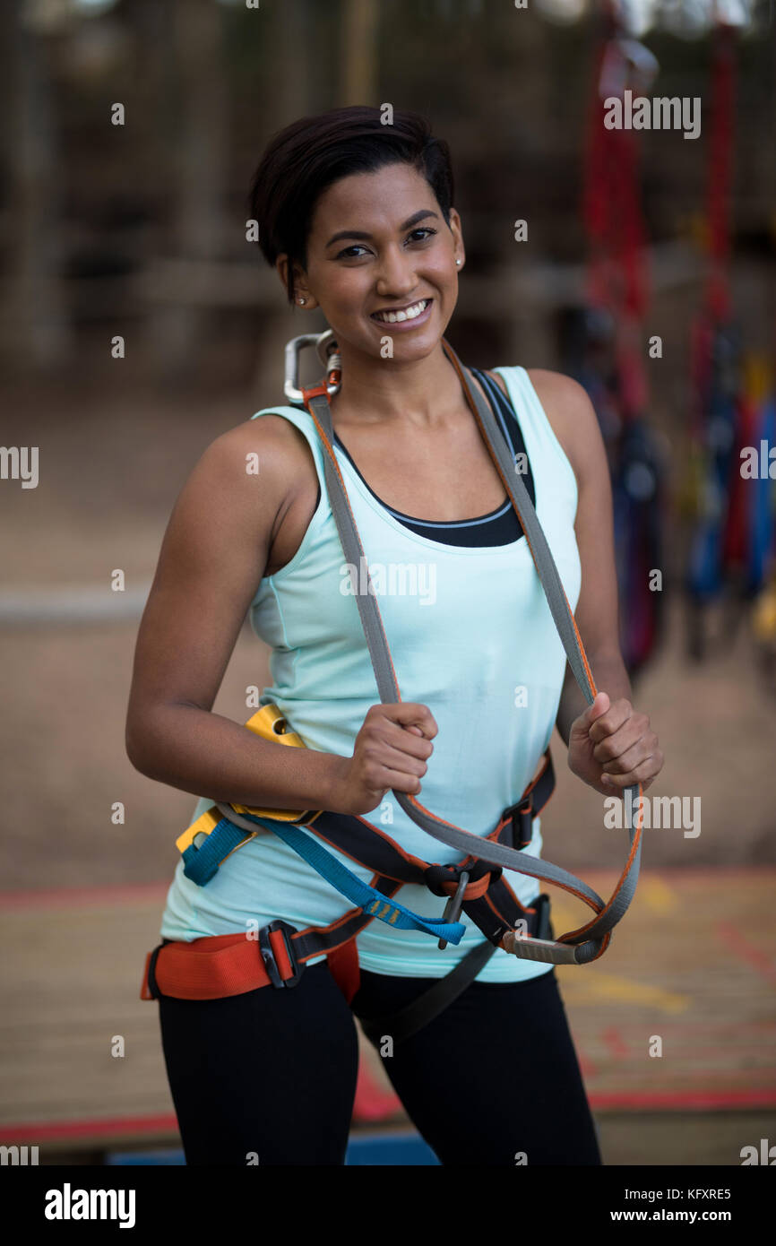 Portrait of smiling woman holding harness in park Stock Photo - Alamy