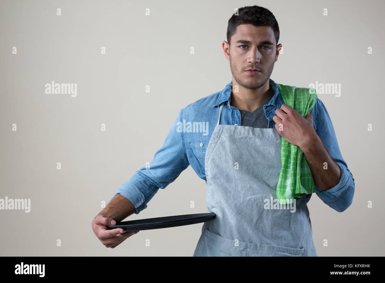 Portrait of waiter standing with a tray and napkin Stock Photo - Alamy