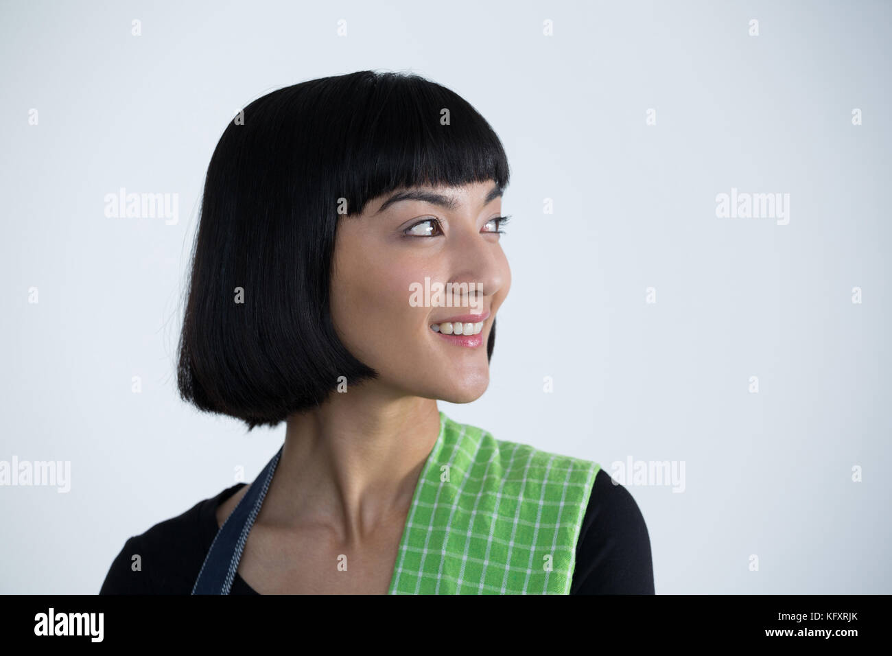 Smiling waitress standing against white background Stock Photo - Alamy