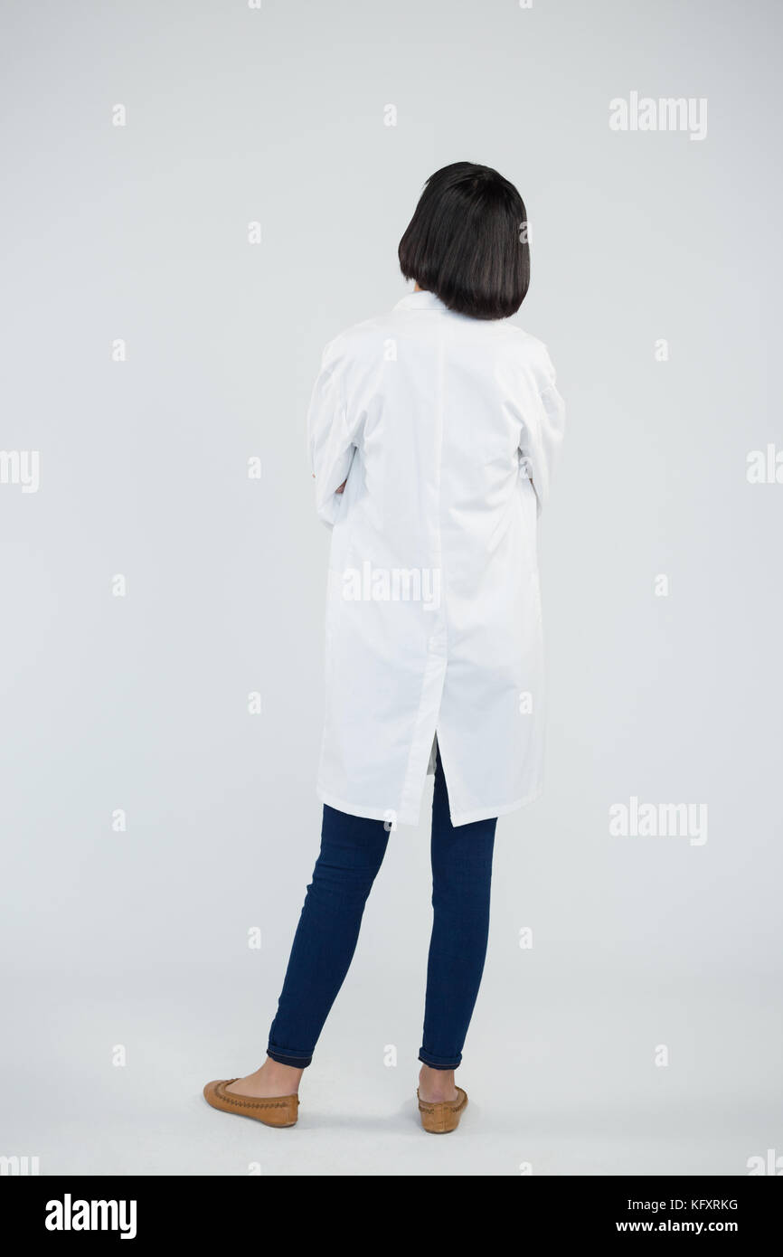 Rear view of doctor standing against white background Stock Photo - Alamy
