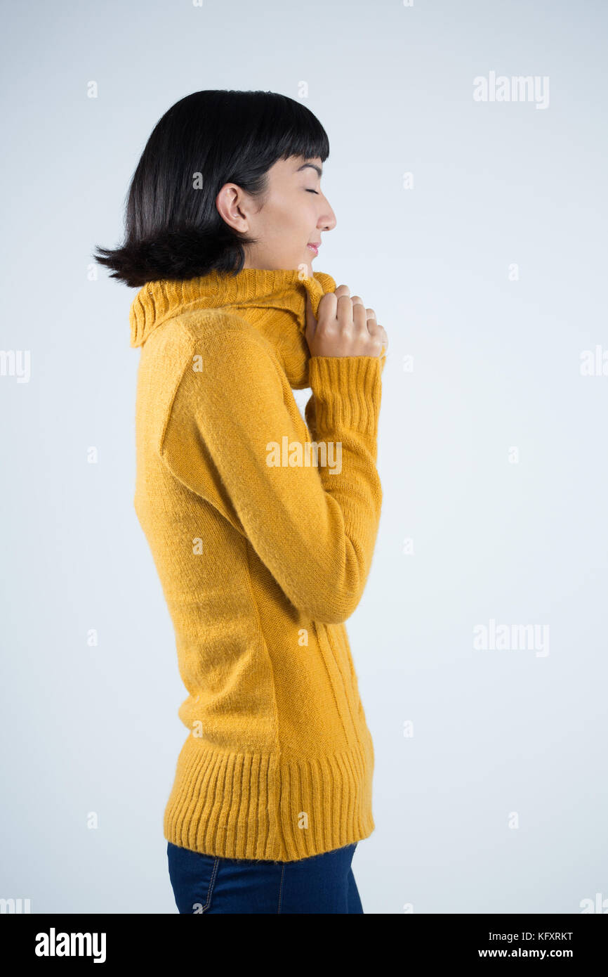Blissful woman in winter clothing posing against white background Stock ...