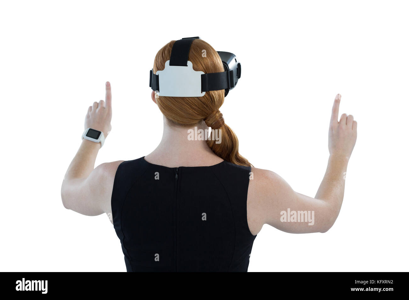 Rear view of female executive using virtual reality headset Stock Photo ...