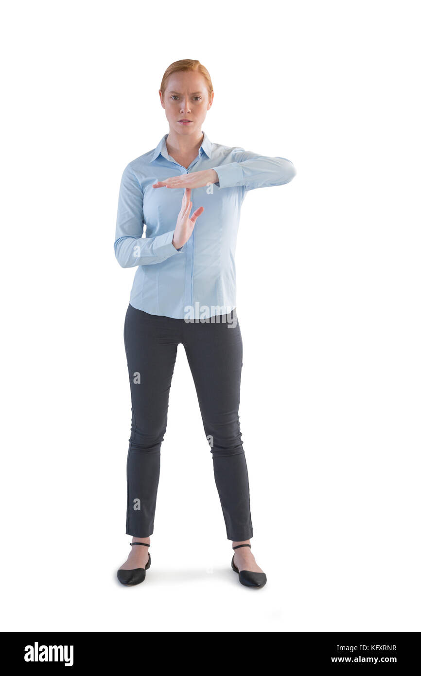 Female executive making time out sign against white background Stock ...