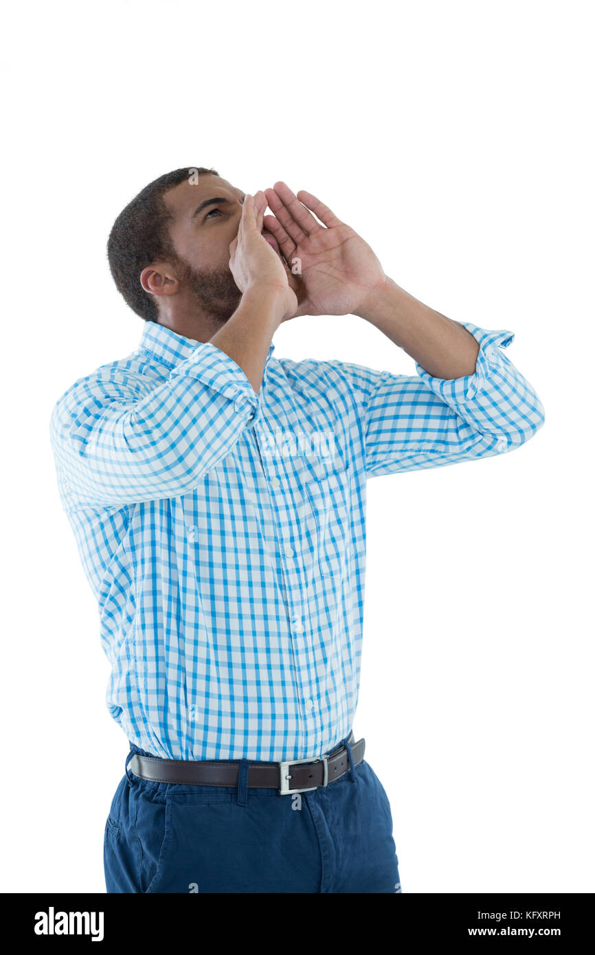 Young male executive shouting against white background Stock Photo - Alamy