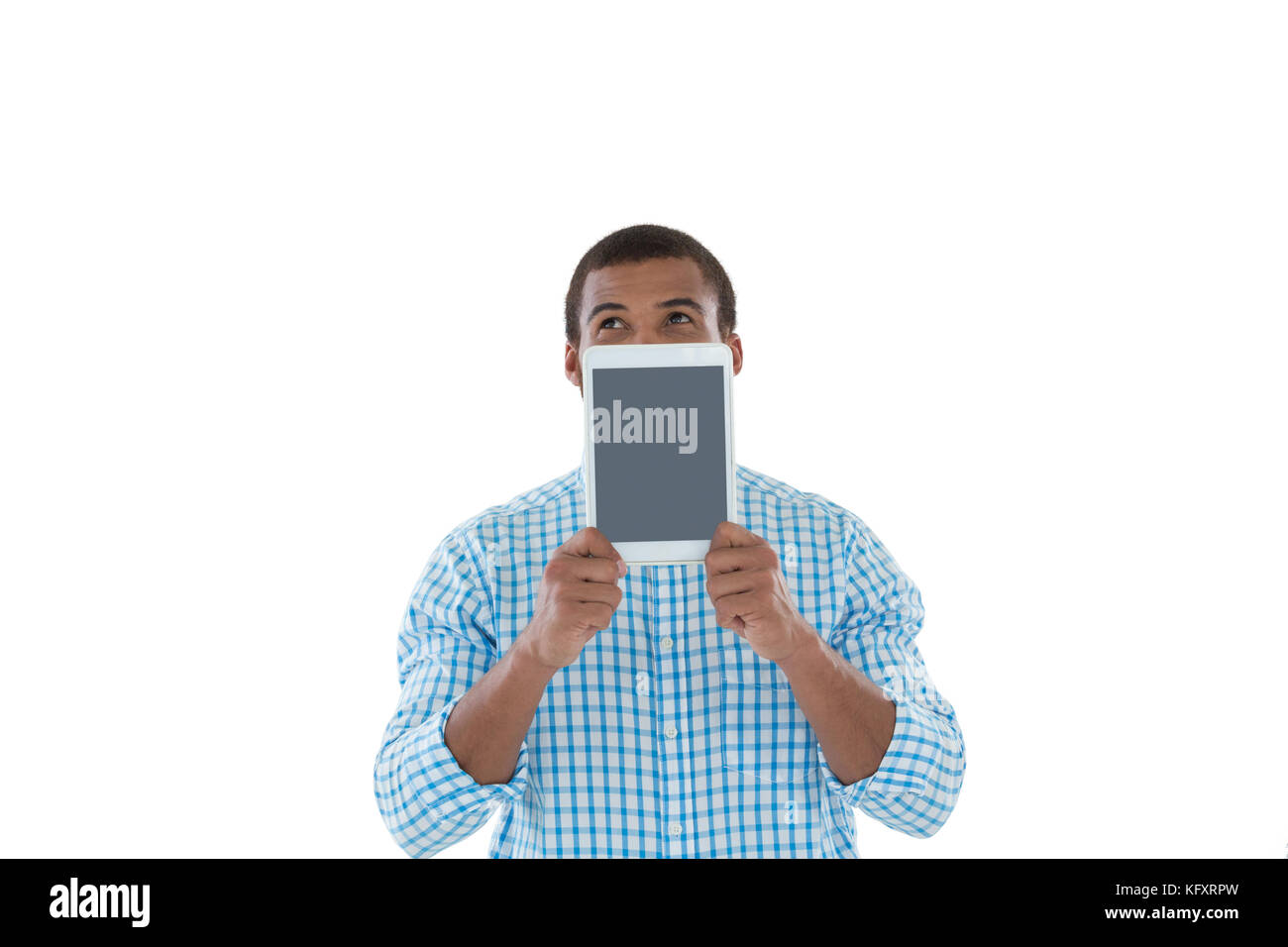 Male executive hiding his face with digital tablet against white ...