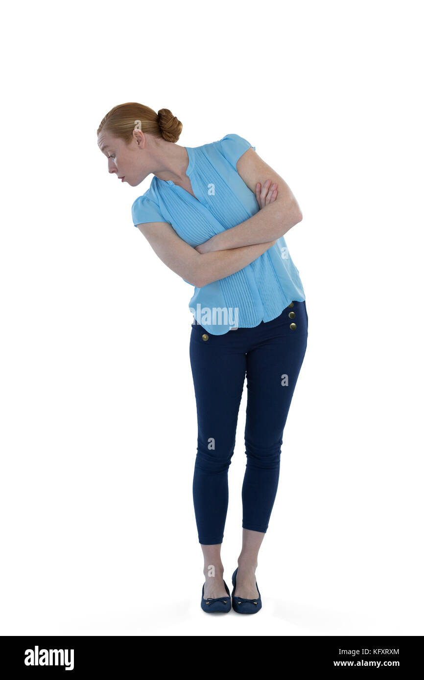 Female executive looking down against white background Stock Photo - Alamy