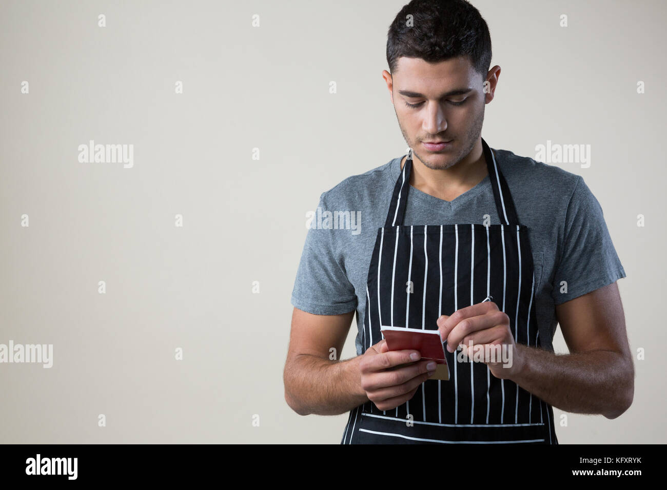 Close-up of waiter writing down an order in the notepad Stock Photo - Alamy