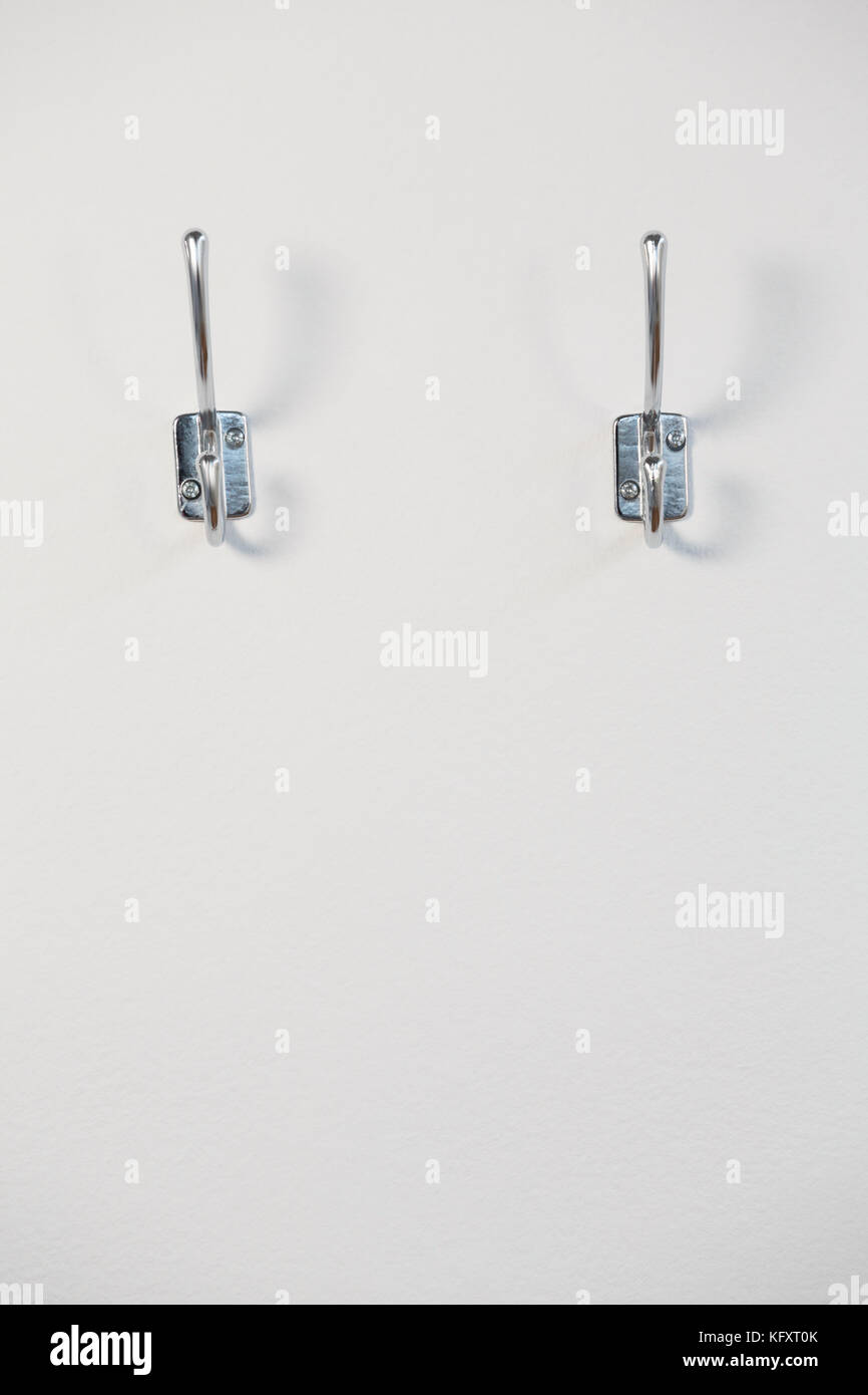 Empty hooks attached on wall Stock Photo - Alamy