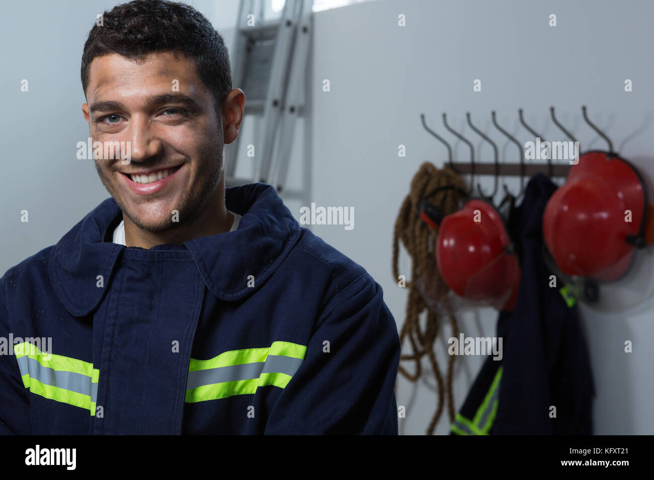 Portrait of smiling fireman standing in the office Stock Photo - Alamy