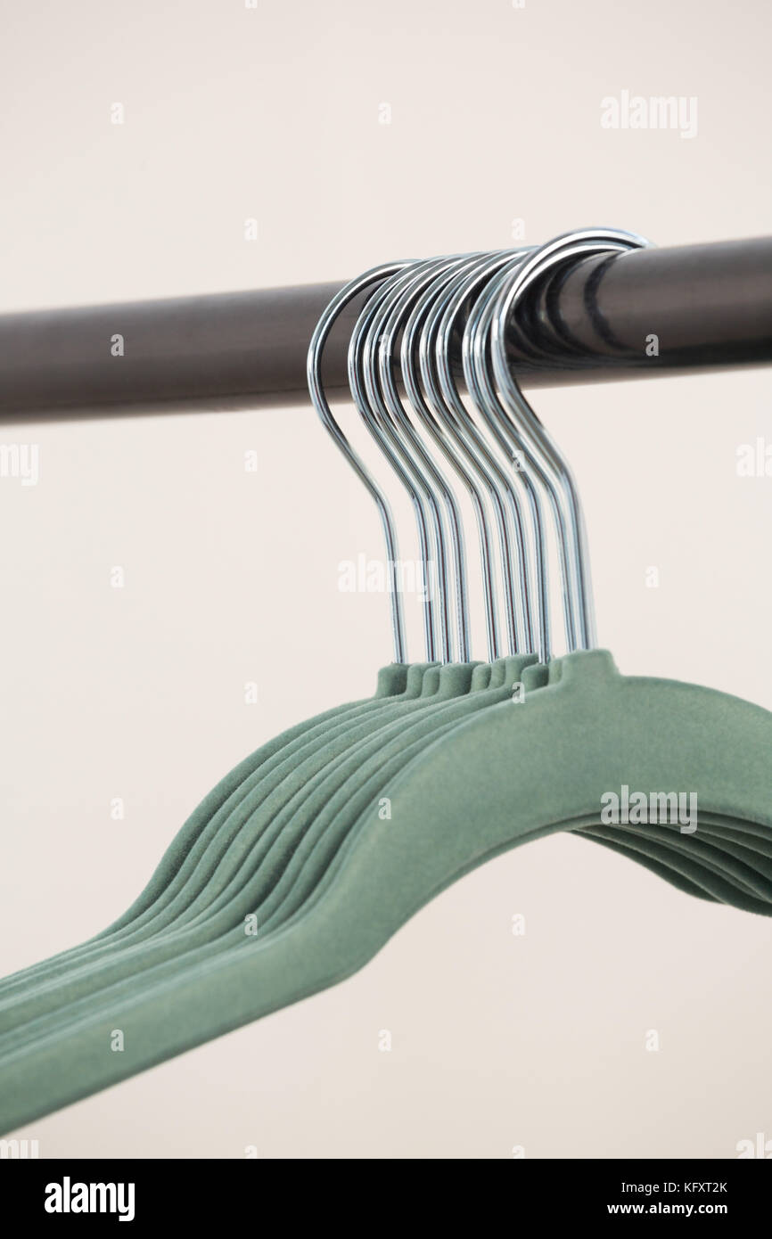 Close-up of hangers arranged on clothes rack Stock Photo - Alamy
