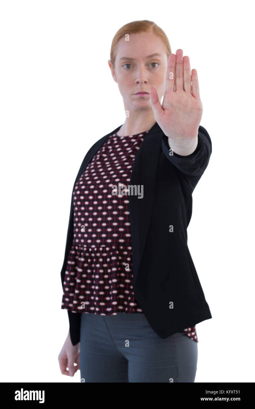 Young female executive making stop sign against white background Stock ...