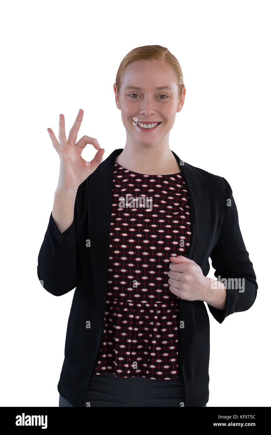 Woman showing hand OK sign against white background Stock Photo - Alamy