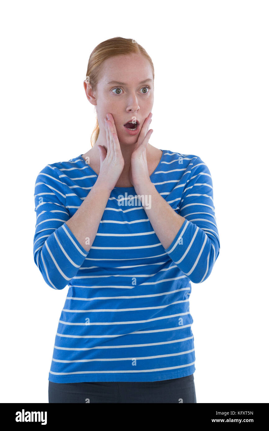 Close-up of woman with shocked facial expression standing with hand on ...