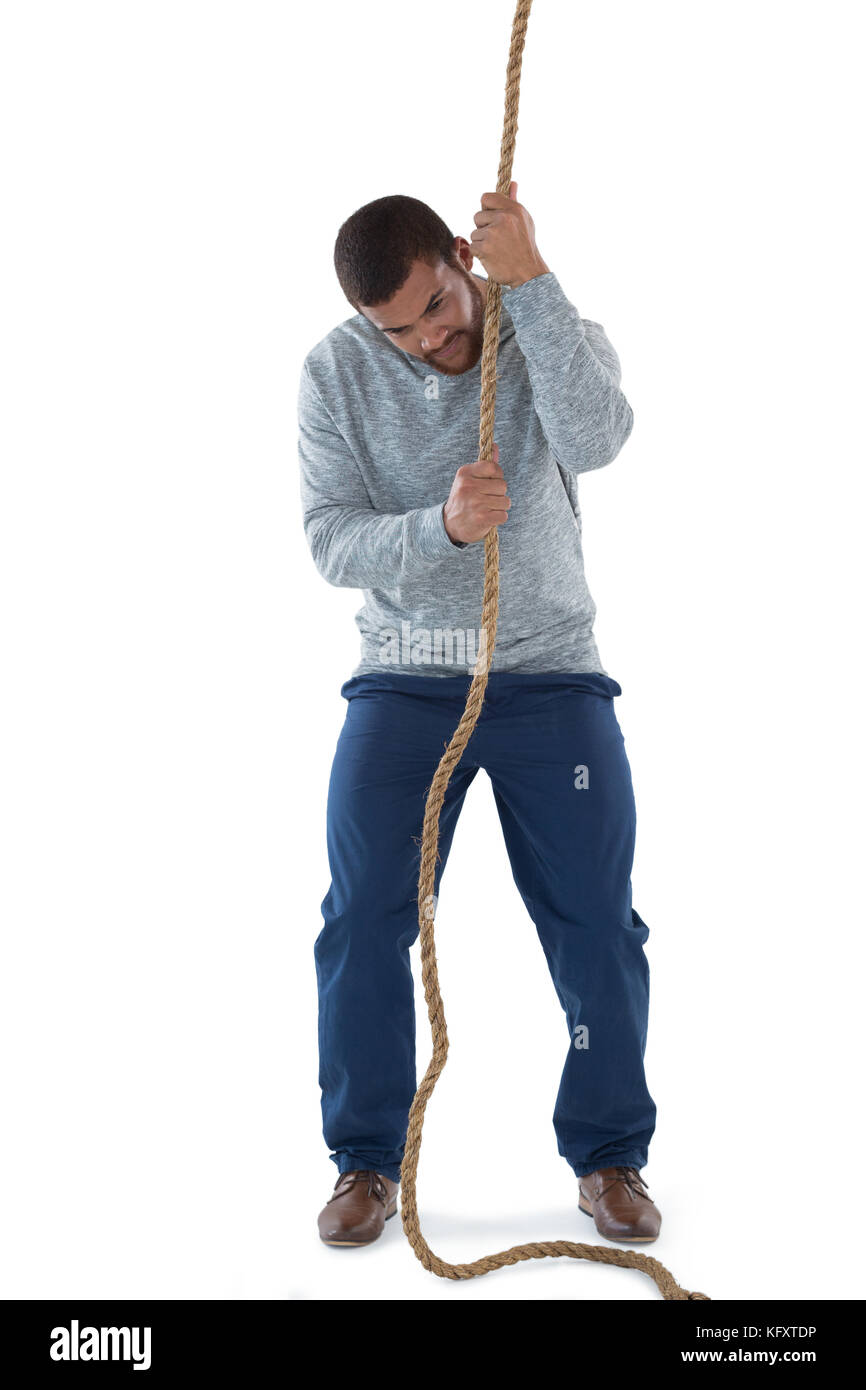 Young male executive pulling the rope against white background Stock ...