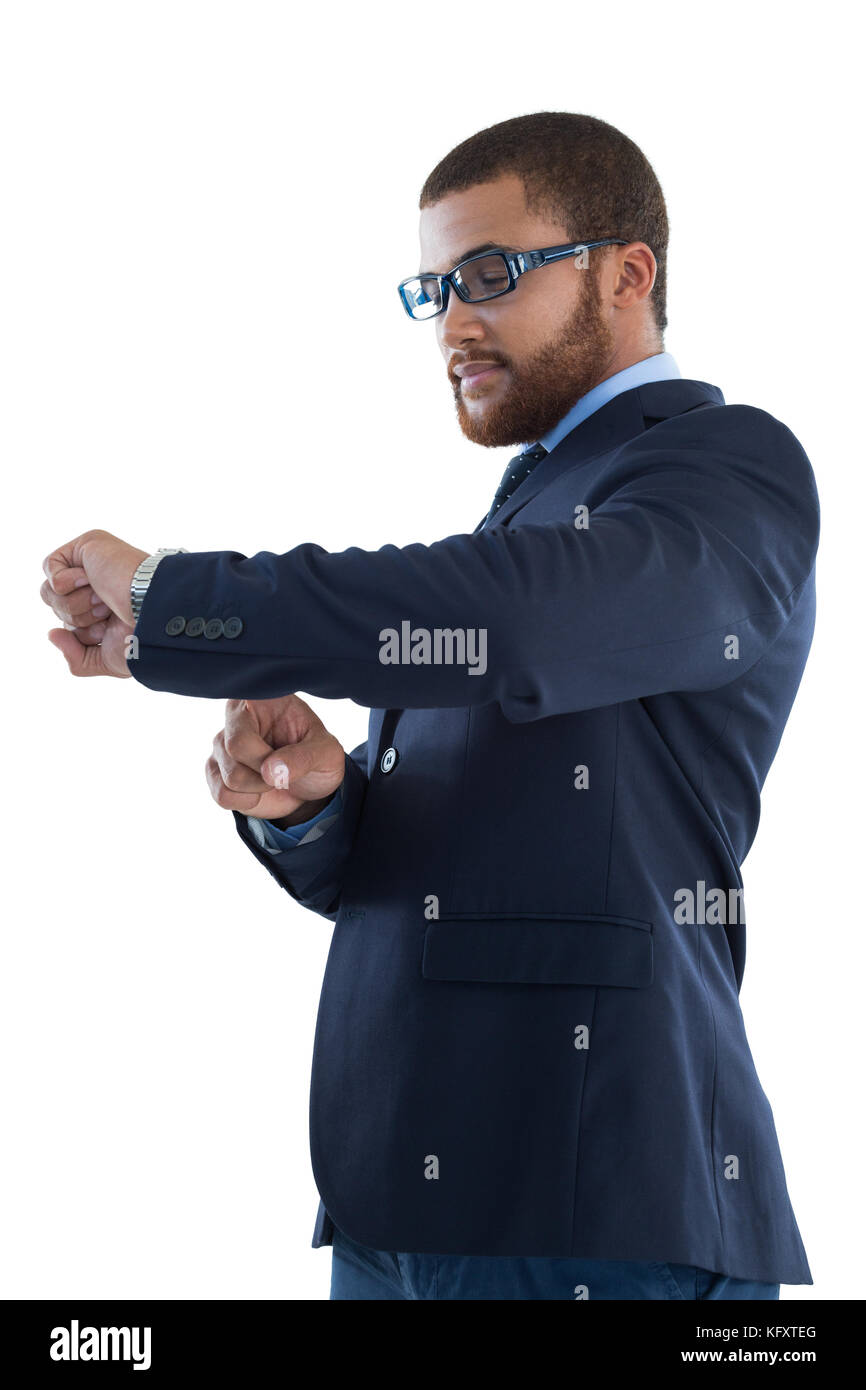 Businessman checking time on his watch against white background Stock ...