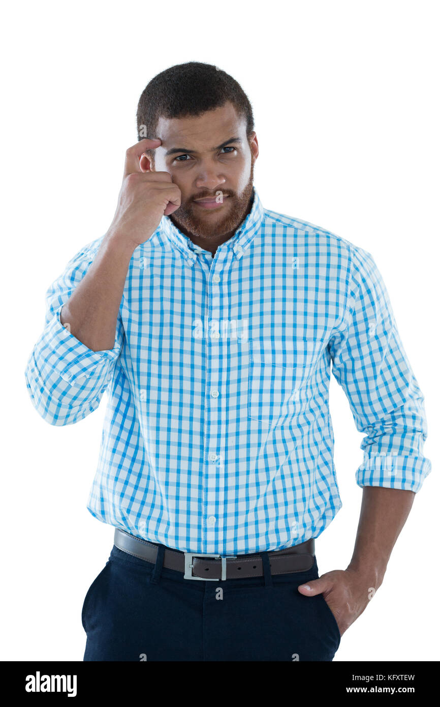 Thoughtful male executive standing against white background Stock Photo ...