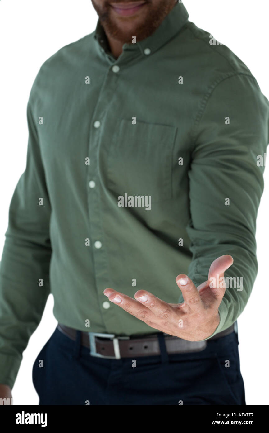 Mid-section of male executive pretending to hold an invisible object ...