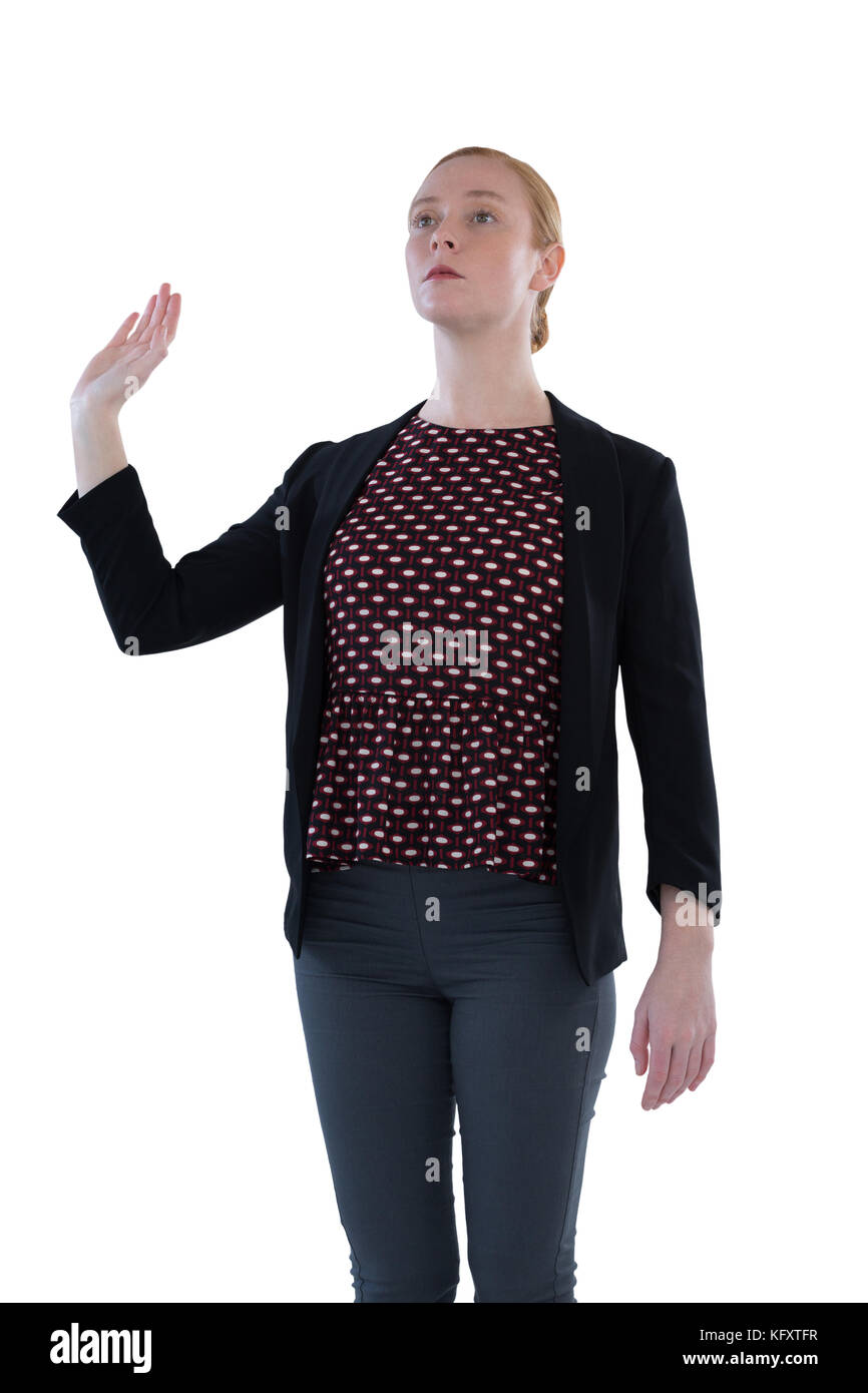 Young female executive gesturing against white background Stock Photo ...