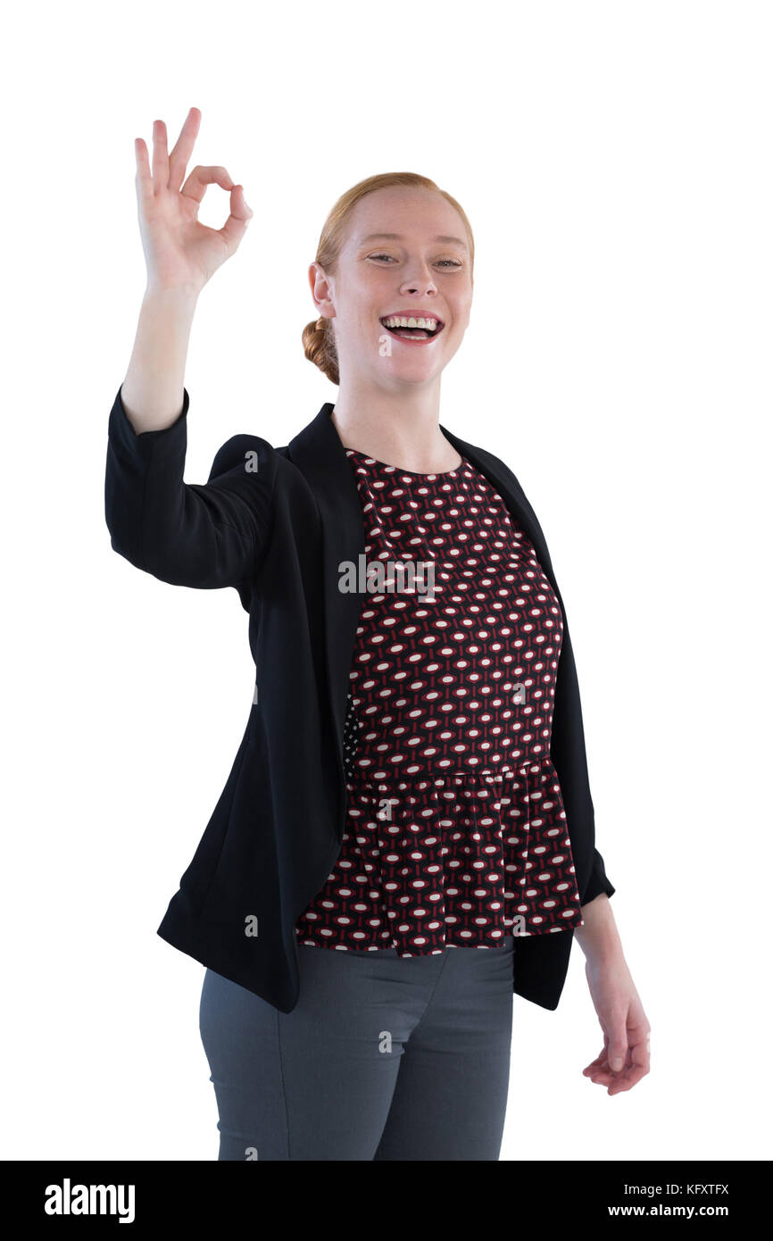 Woman showing hand OK sign against white background Stock Photo - Alamy