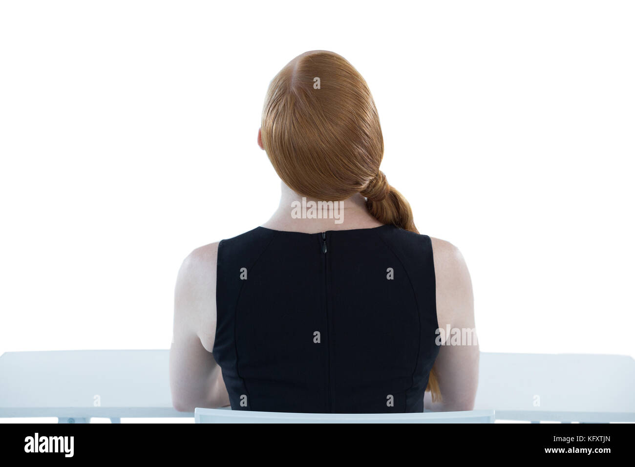 Rear view of female executive standing against white background Stock ...