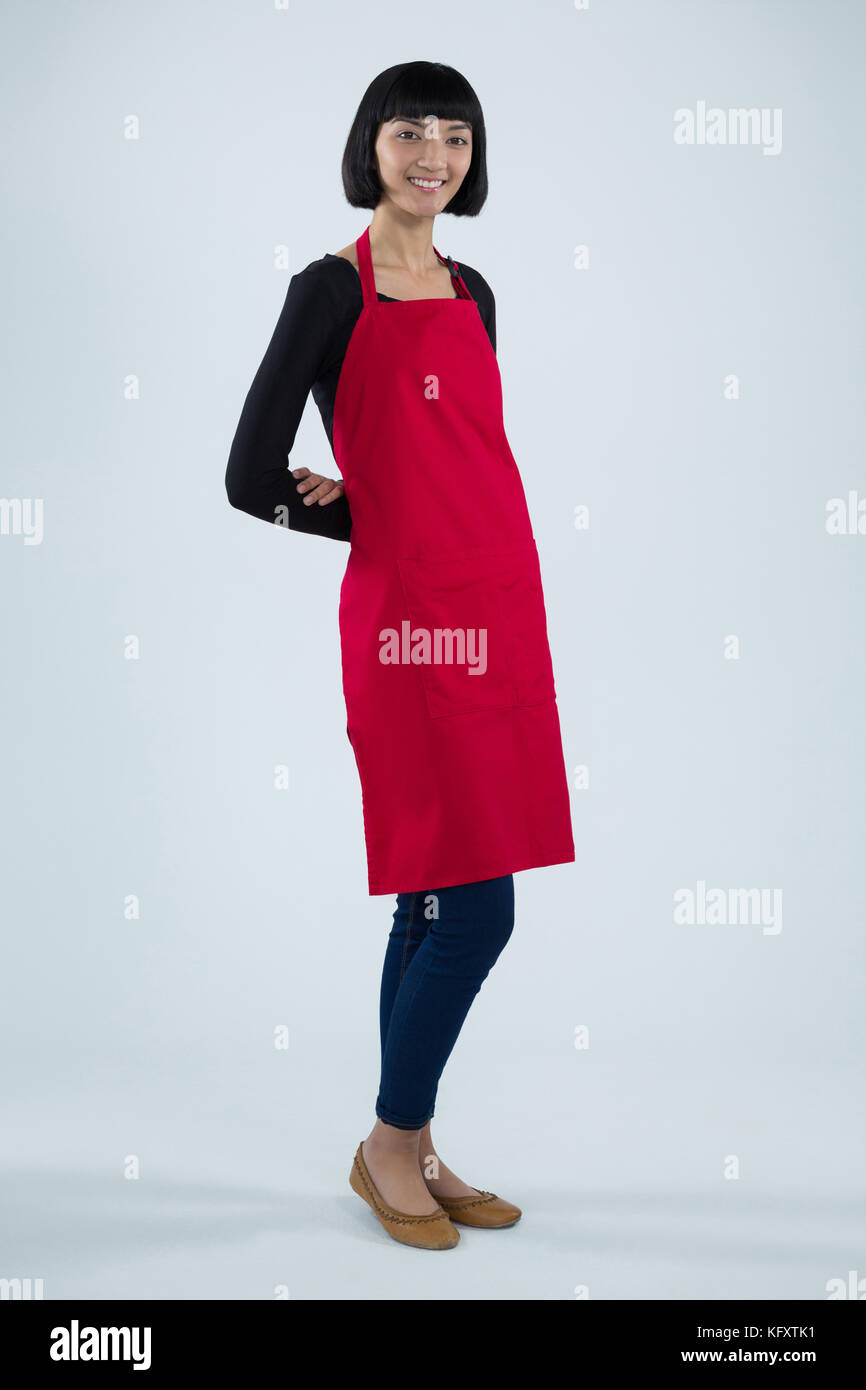 Portrait of smiling waitress standing against white background Stock ...