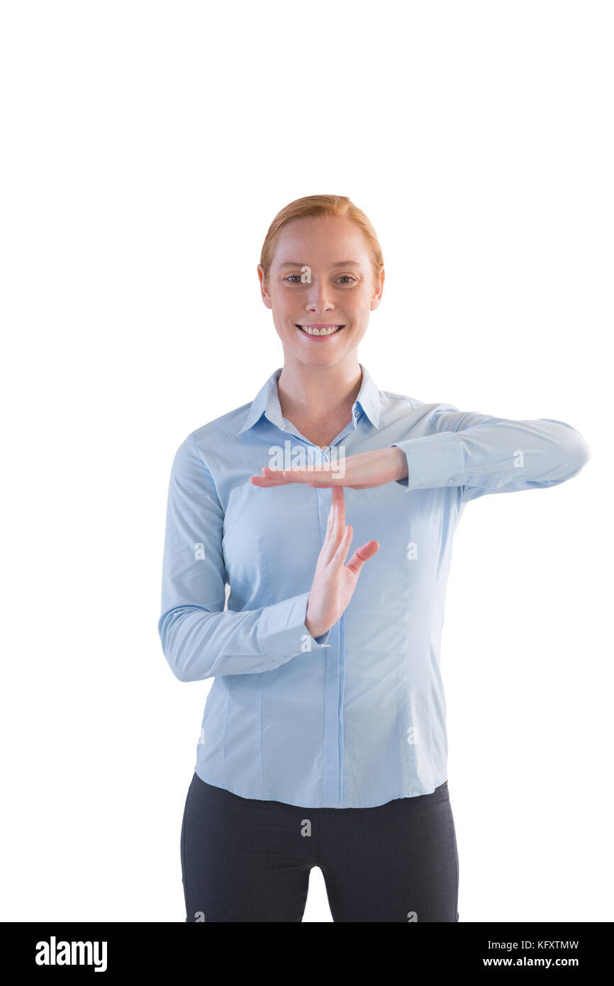 Female executive making time out sign against white background Stock ...