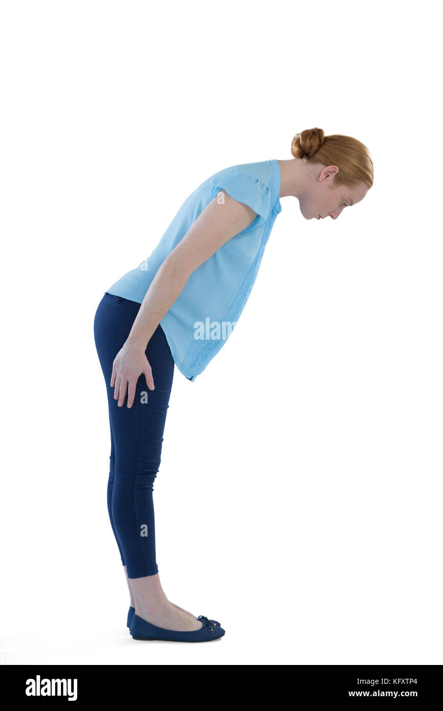 Female executive looking down against white background Stock Photo - Alamy