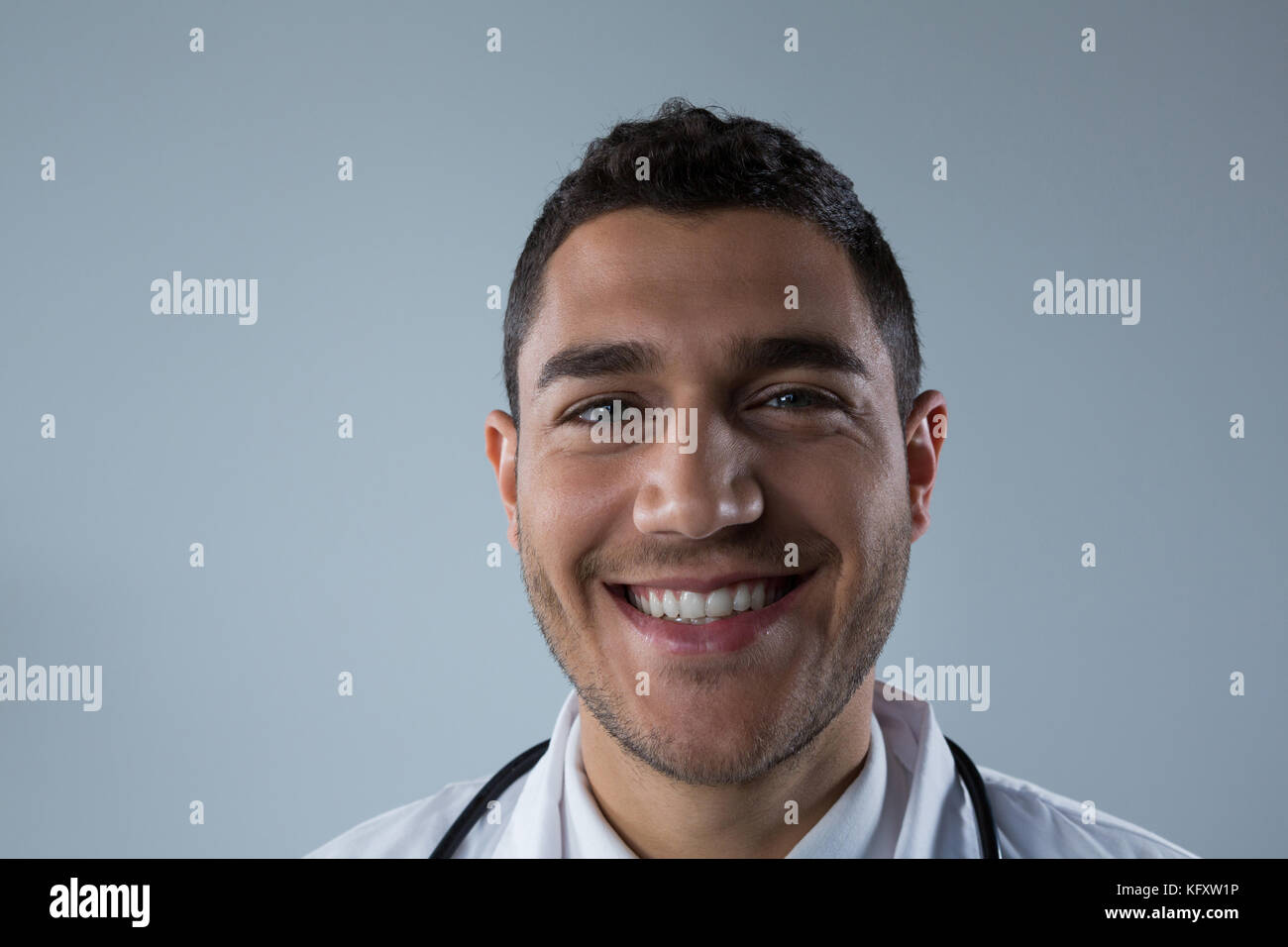 Portrait of smiling doctor against white background Stock Photo - Alamy
