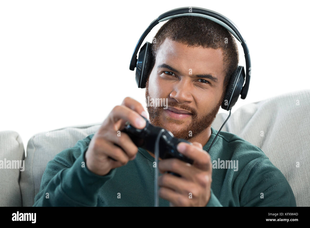Smiling man playing video game against white background Stock Photo - Alamy