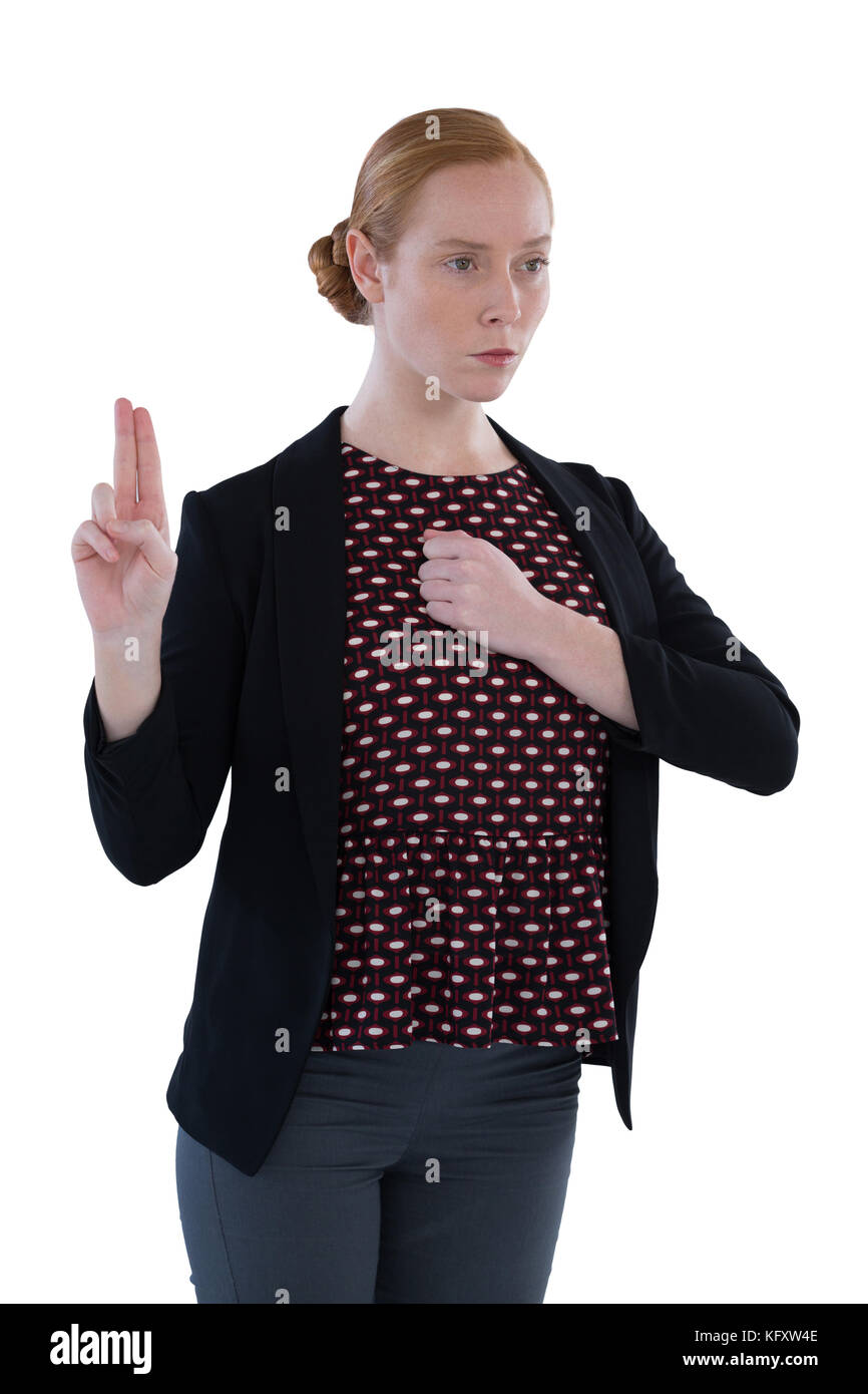 Young female executive gesturing against white background Stock Photo ...