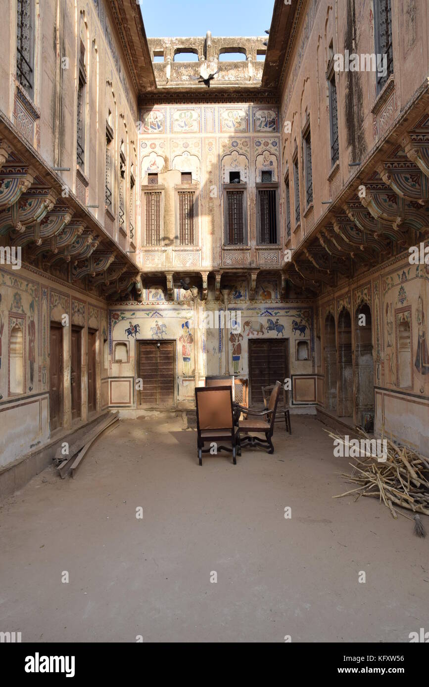 The courtyard of an old haveli with beautiful decorations and paintings ...