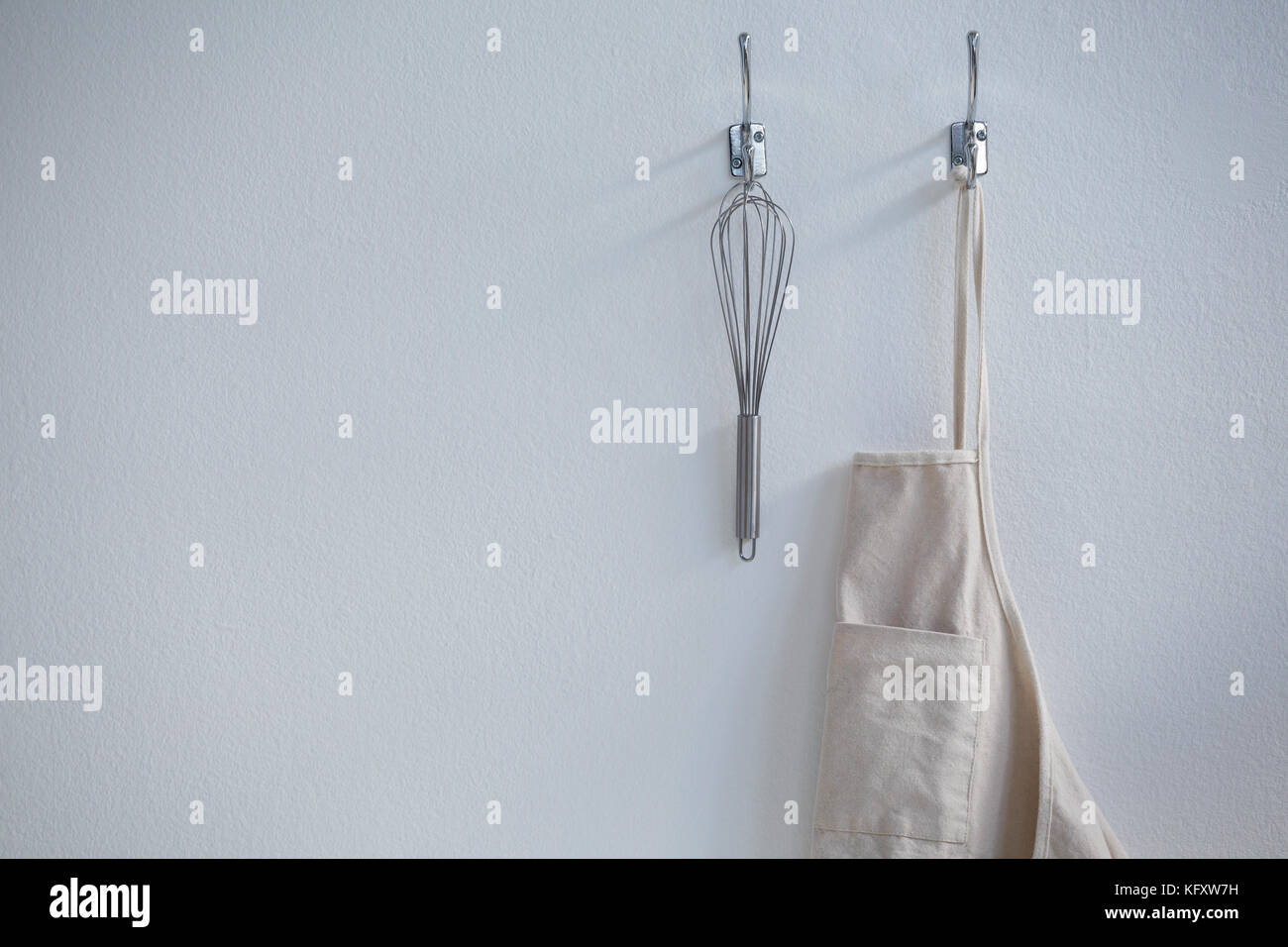 Close-up of apron and whisker hanging on hook Stock Photo - Alamy