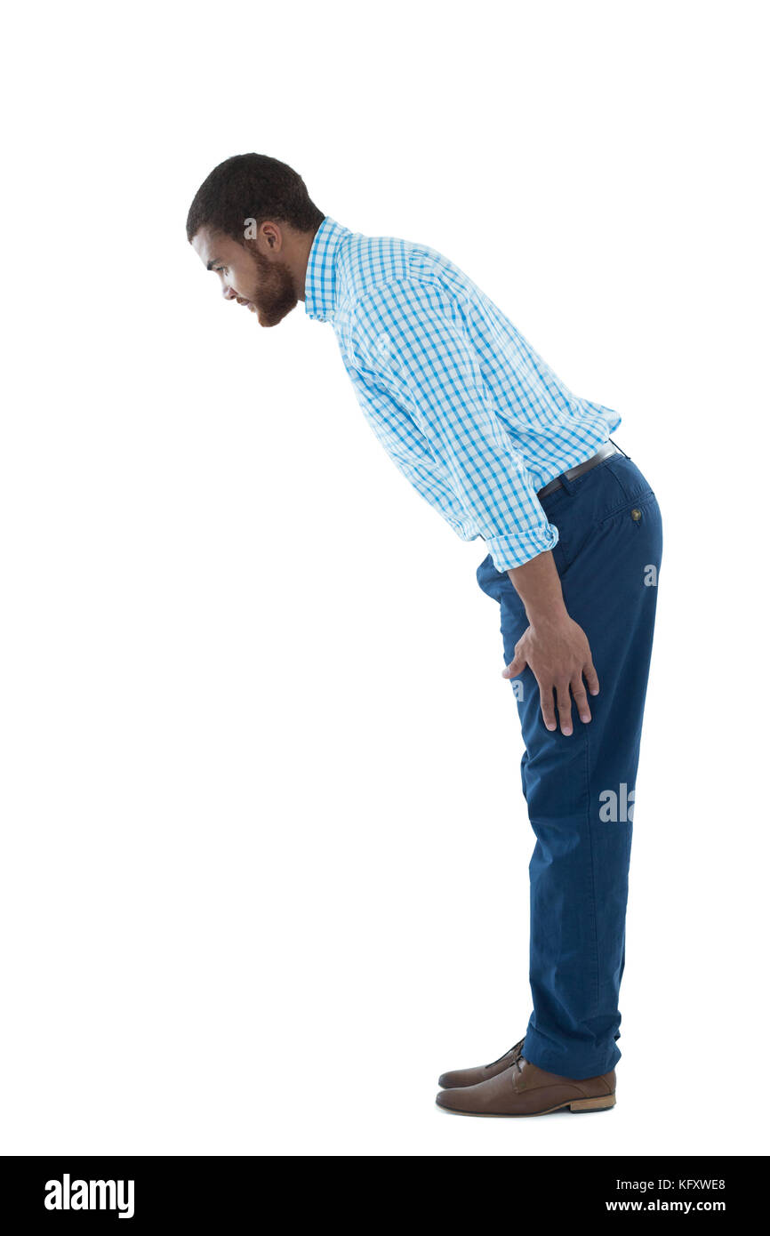 Young male executive looking down against white background Stock Photo ...